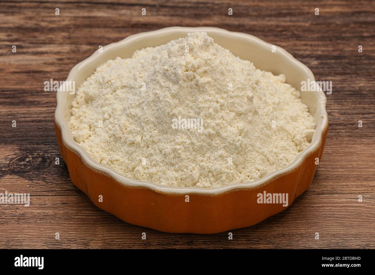 Wheat flour heap in the bowl for cooking Stock Photo - Alamy