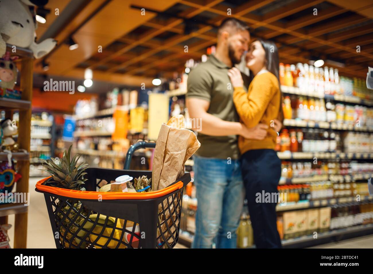 Love family couple hugs in grocery store Stock Photo - Alamy