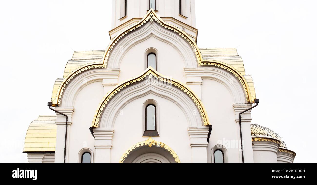 Beautiful design elements in a church, golden vaults and white walls ...