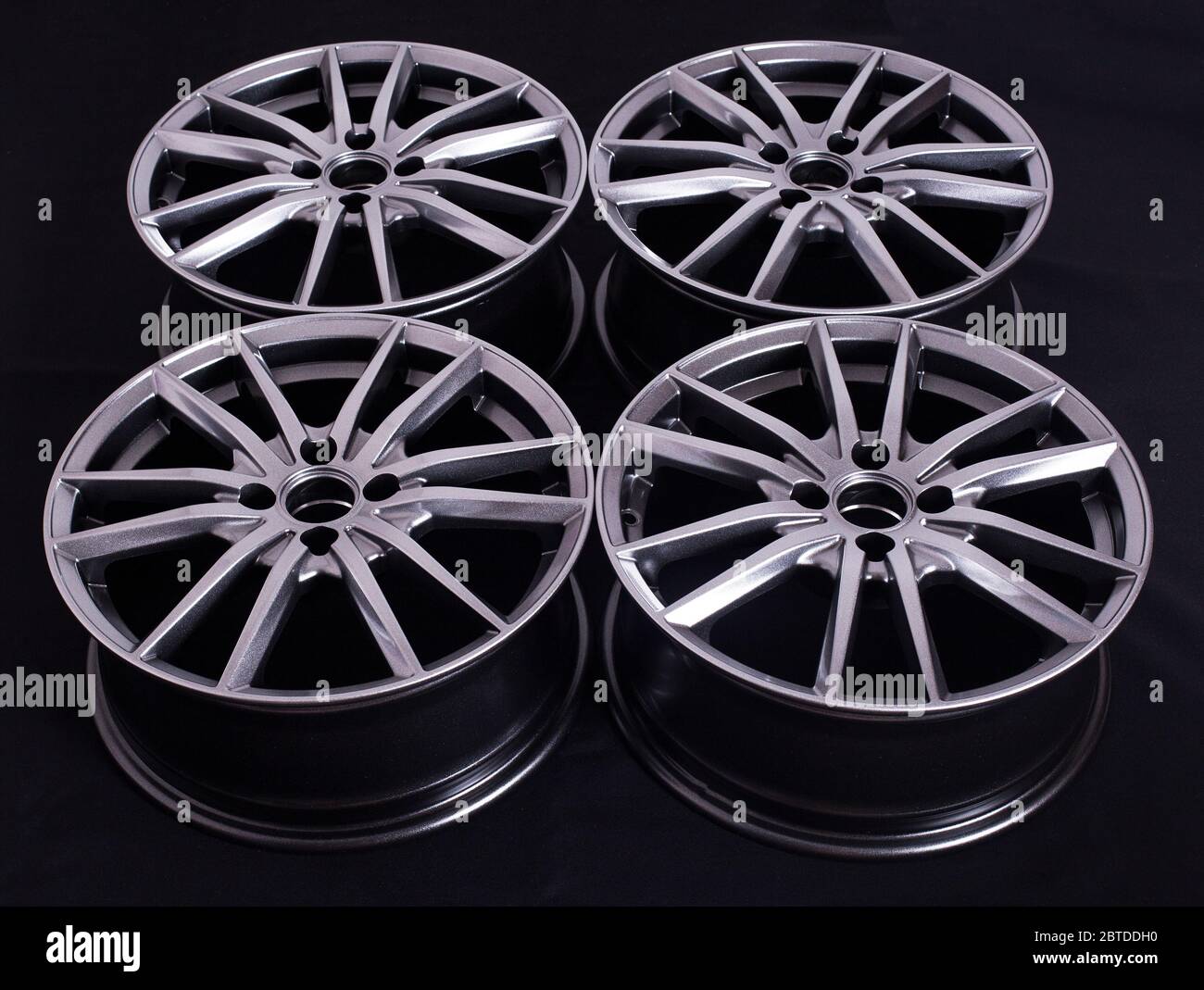 Modern automotive alloy wheel made of aluminum on a black background ...