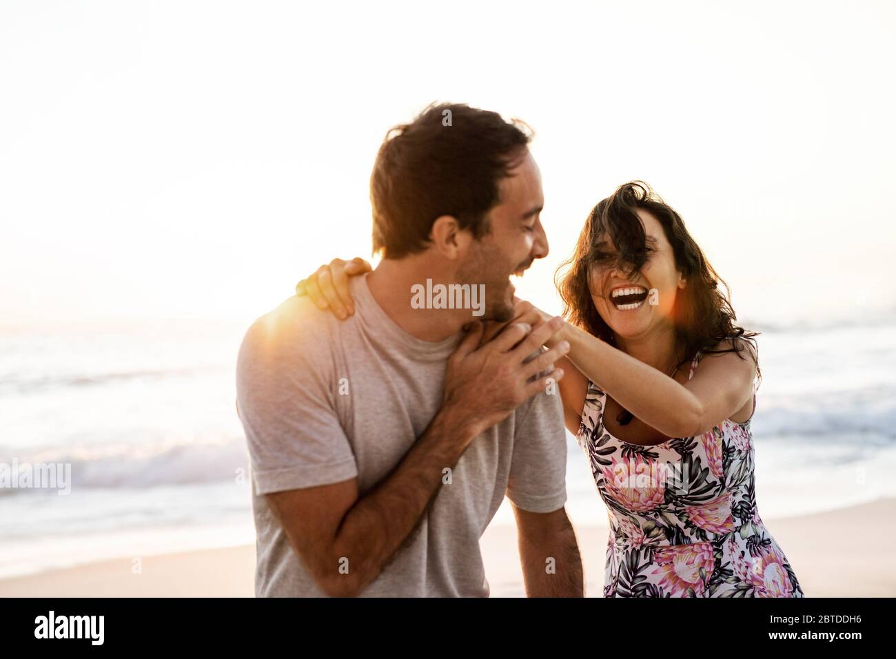Young woman on a beach laughing hi-res stock photography and images - Alamy