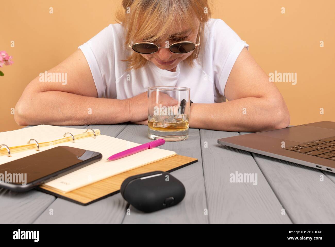 Alcoholic business woman drinks at work sitting at a desk. Alcohol ...