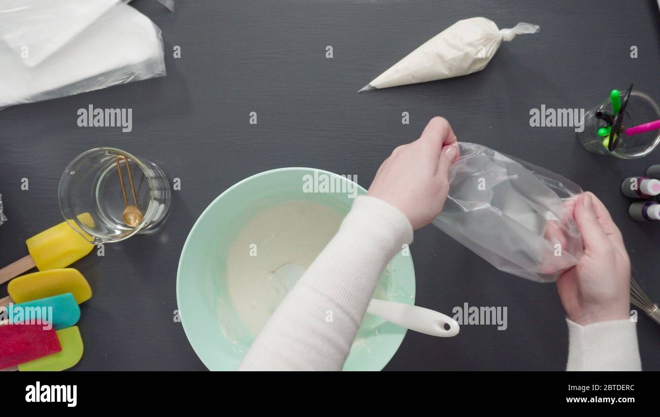 Step by step. Flat lay. Pouring royal icing into the piping bag to ...