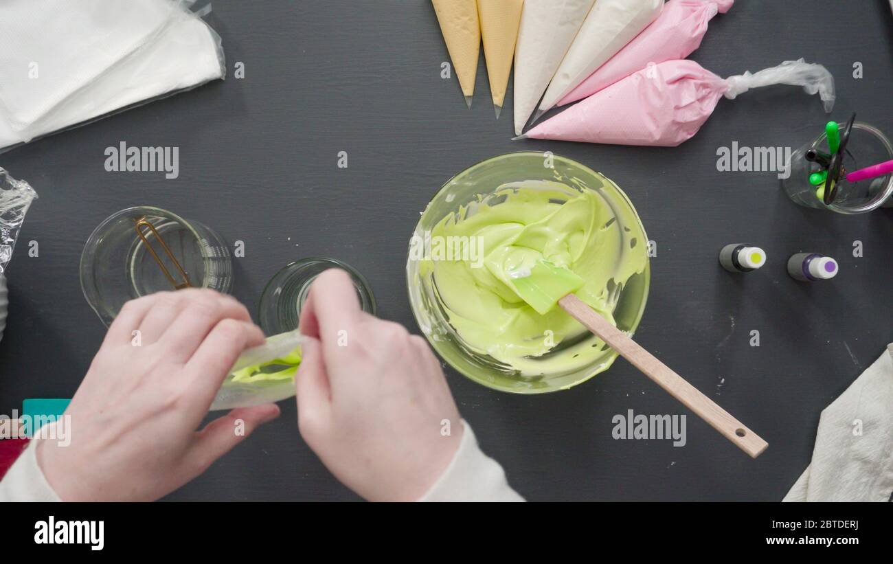 Step by step. Flat lay. Pouring royal icing into the piping bag to ...