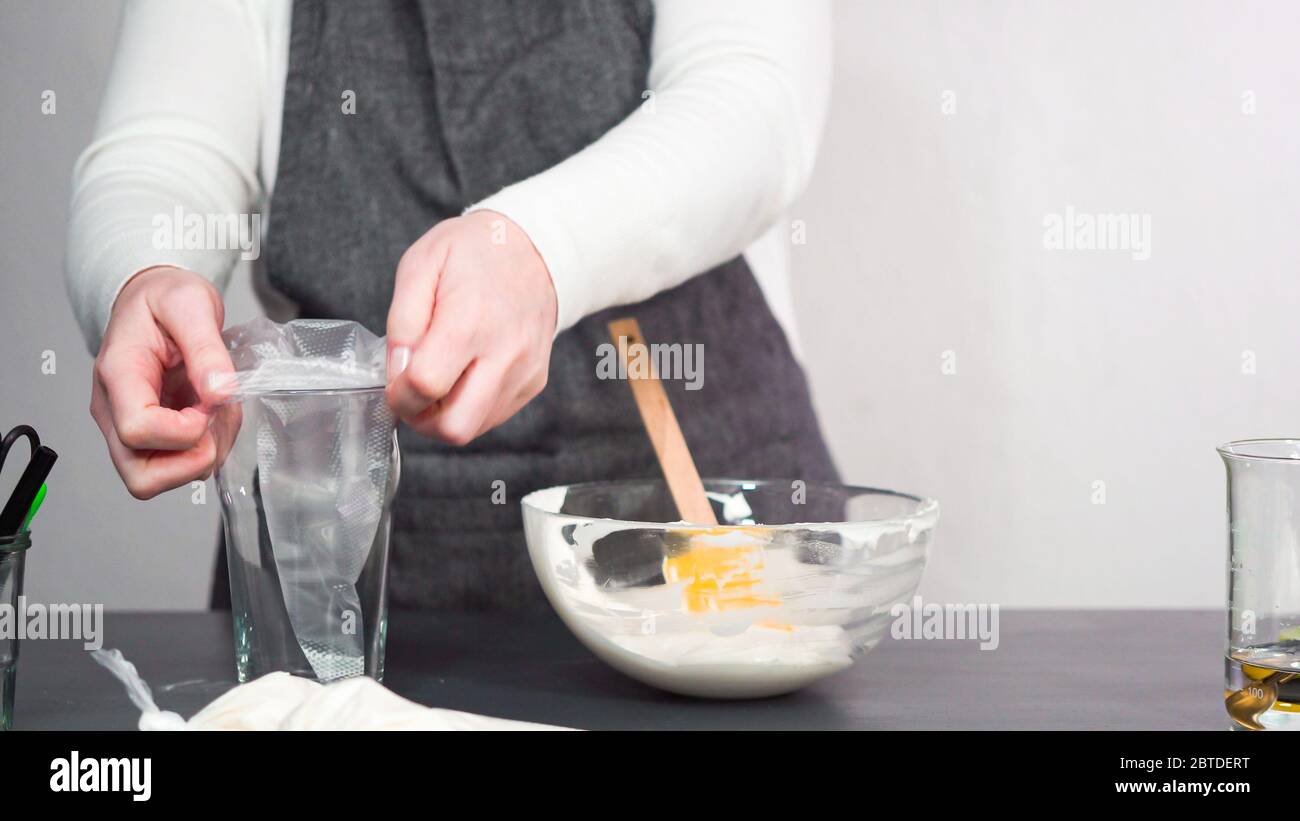 Step by step. Pouring royal icing into the piping bag to decorate sugar ...