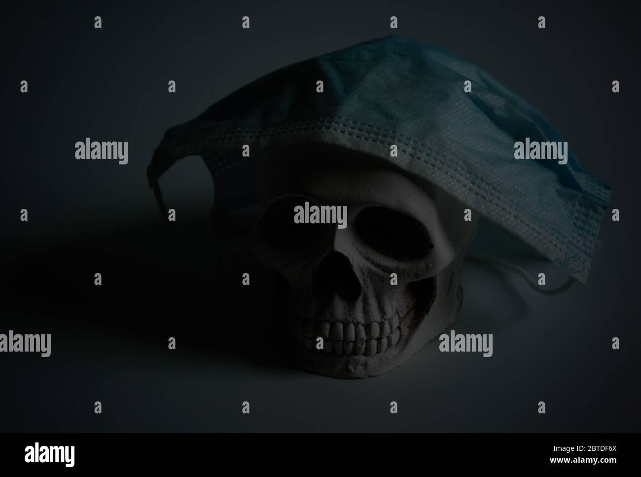 COVID-19 skull wearing face medical mask. Coronavirus death concept ...