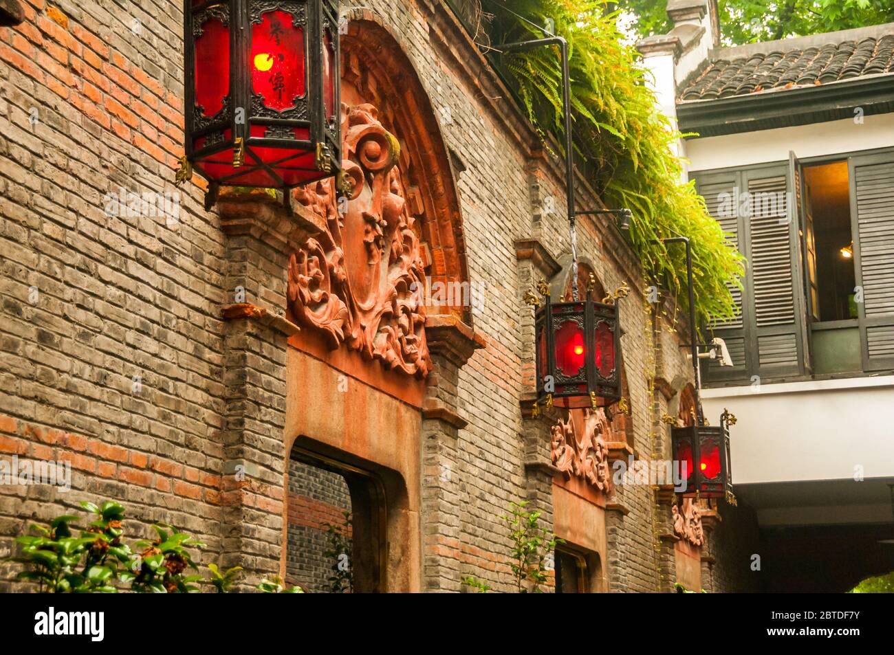 Brickwork and red lanterns on shikumen buildings in an alleyway in ...
