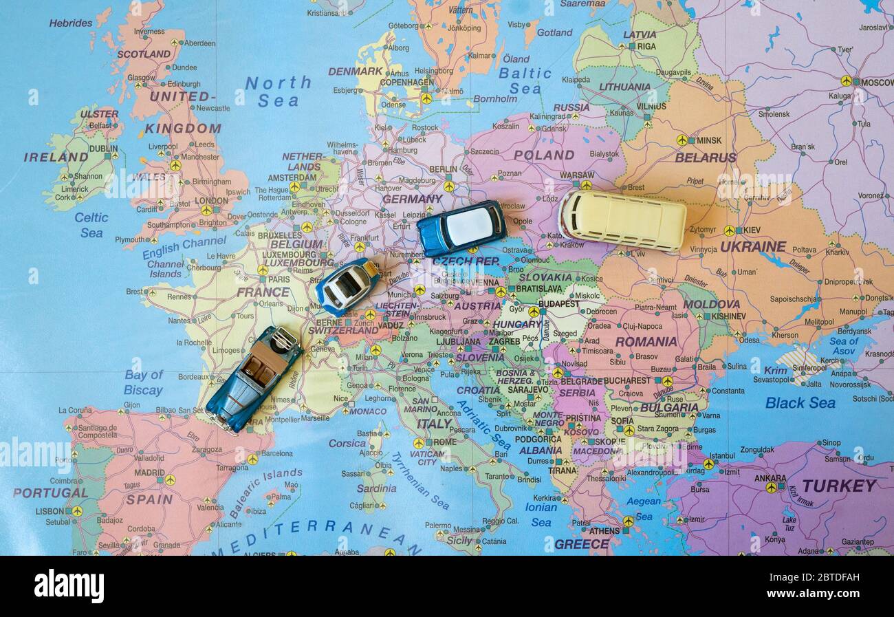 Set of small toy retro cars on the Europe map. Travel by car concept ...