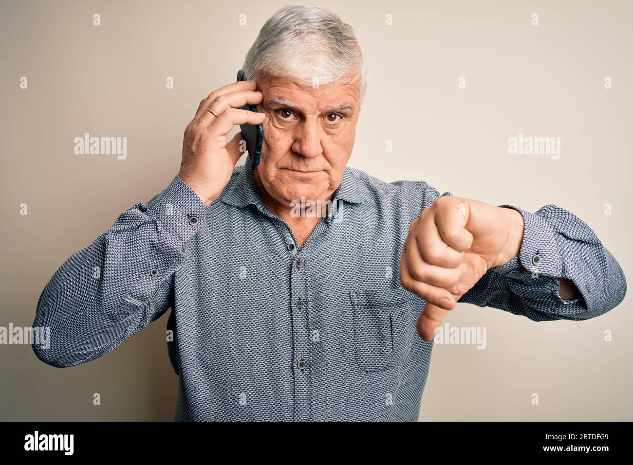 Senior hoary man having conversation talking on the smartphone over ...