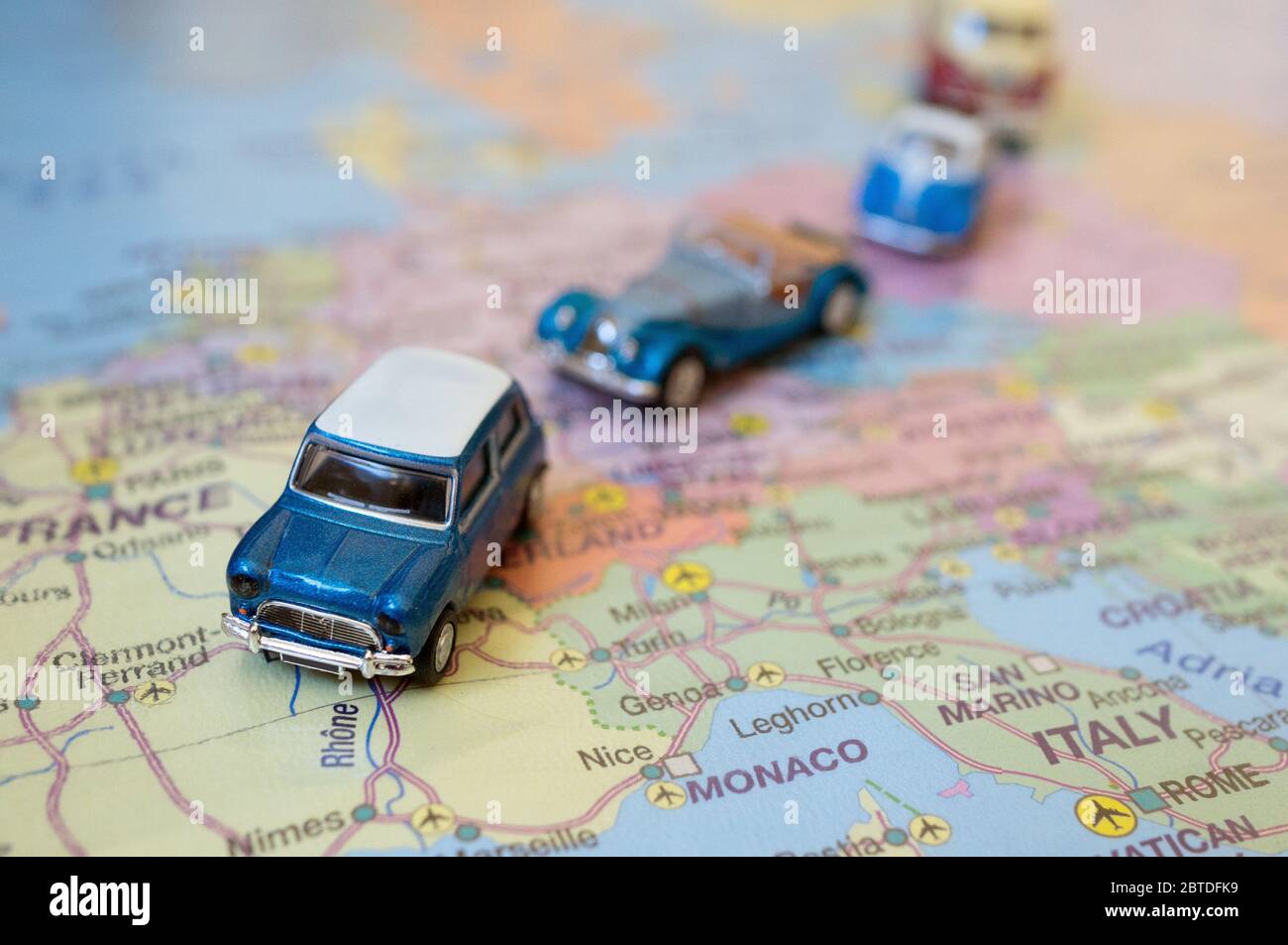 Set of small toy retro cars on the Europe map. Travel by car concept ...