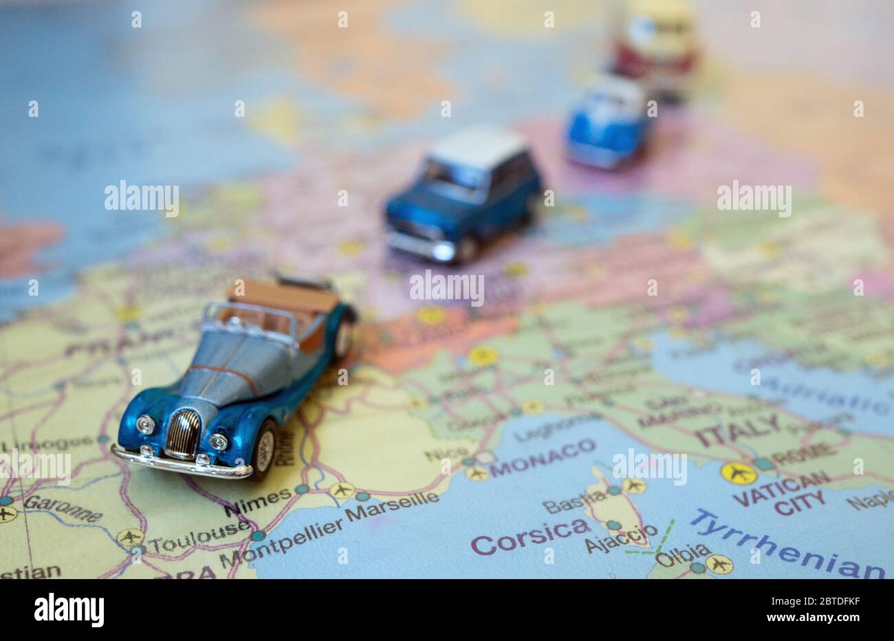 Set of small toy retro cars on the Europe map. Travel by car concept ...