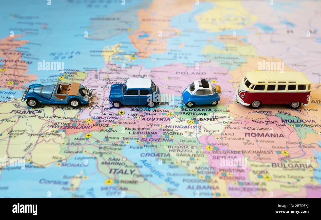 Set of small toy retro cars on the Europe map. Travel by car concept ...