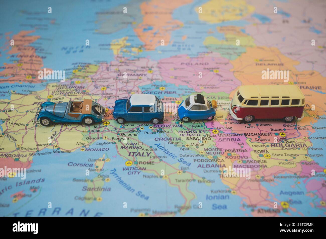 Set of small toy retro cars on the Europe map. Travel by car concept ...