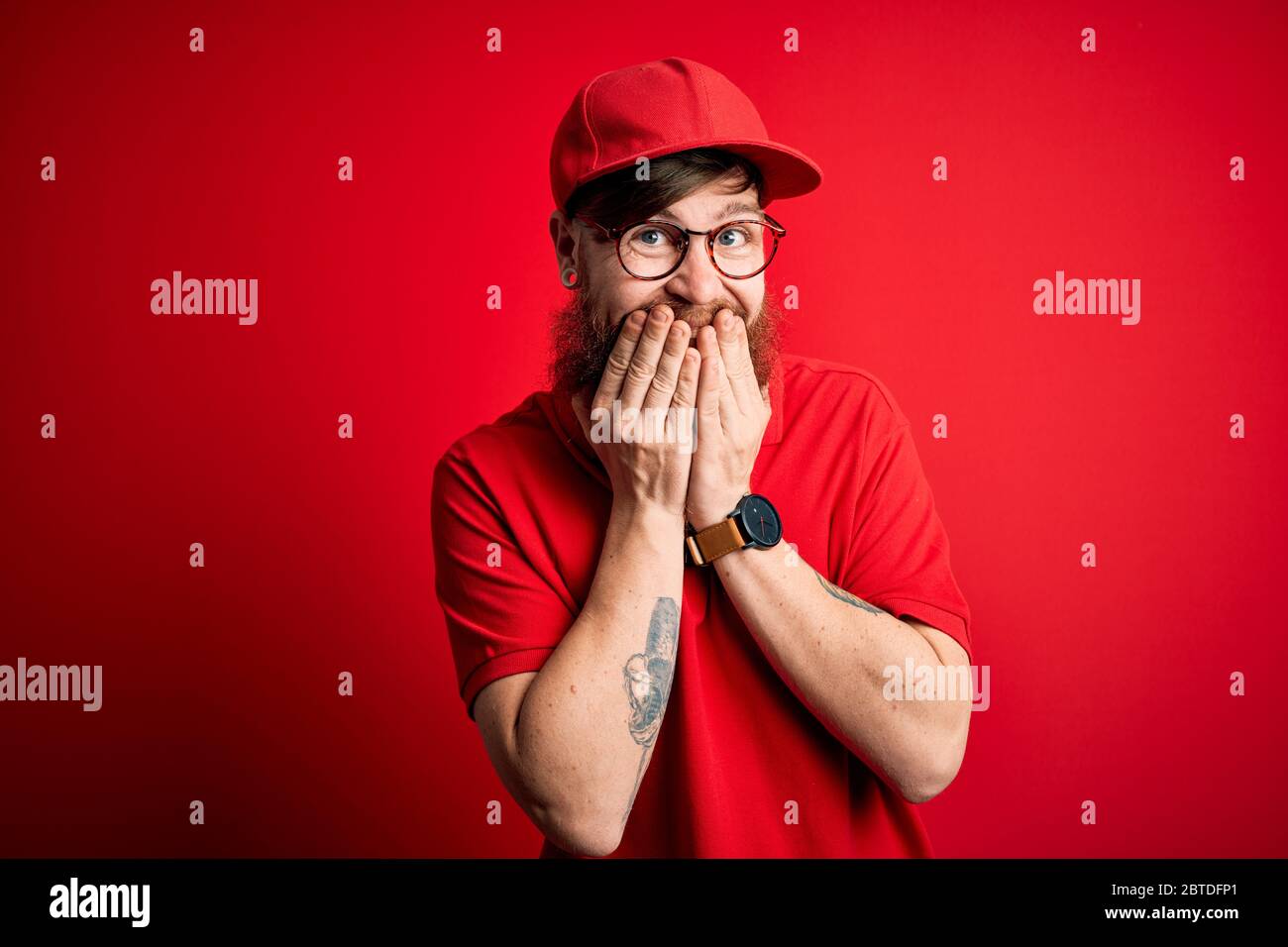 Young handsome delivery man wearing glasses and red cap over isolated ...