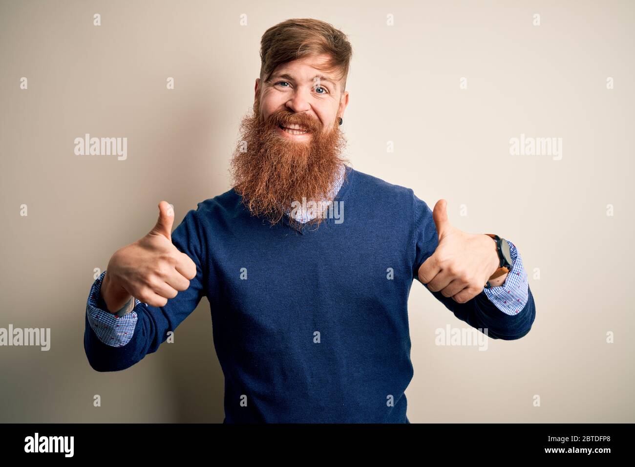 Handsome Irish redhead business man with beard standing over isolated ...