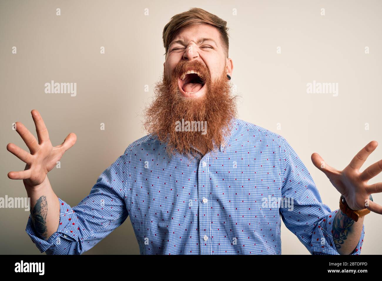 Handsome Irish redhead business man with beard standing over isolated ...