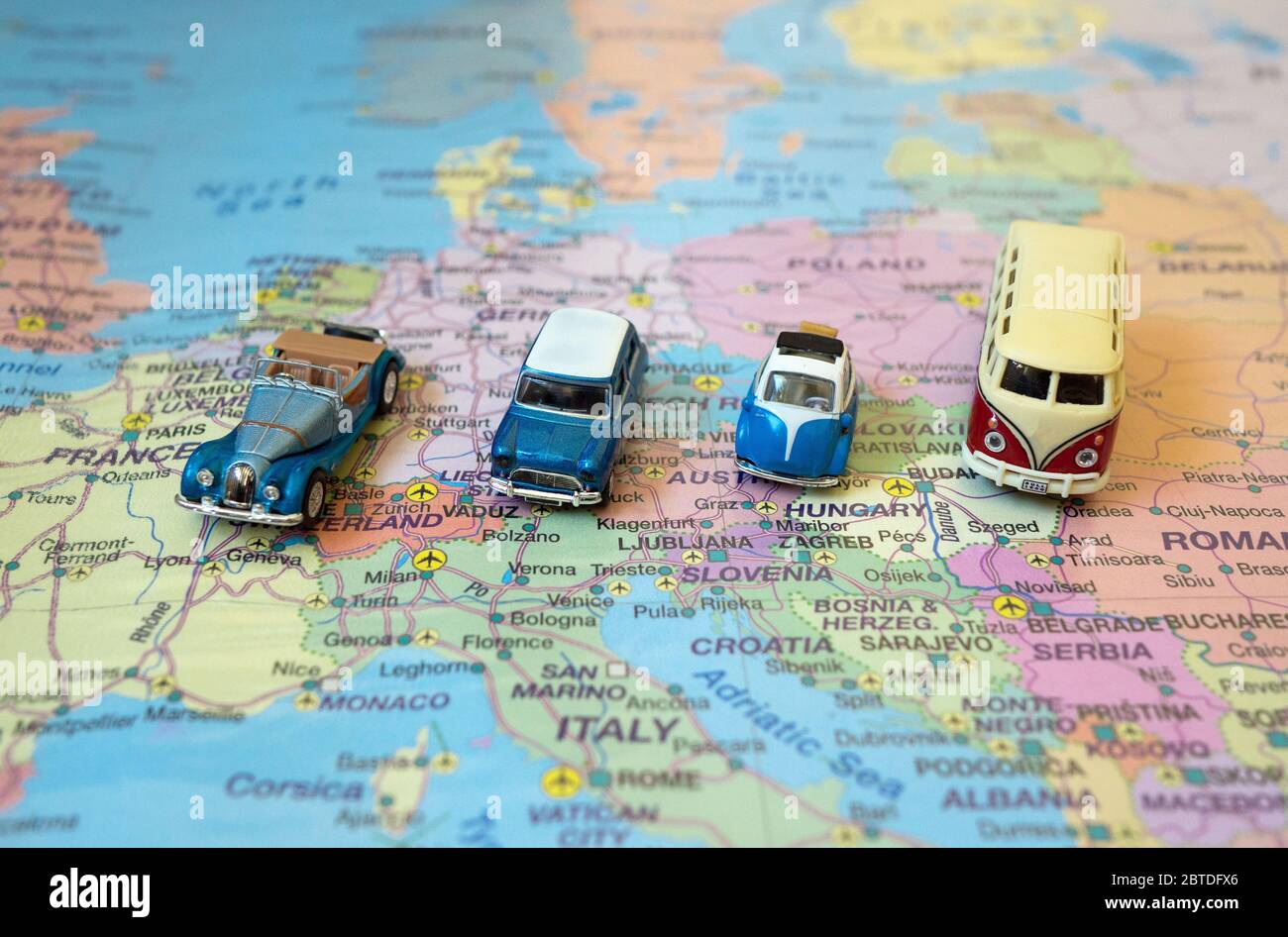 Set of small toy retro cars on the Europe map. Travel by car concept ...