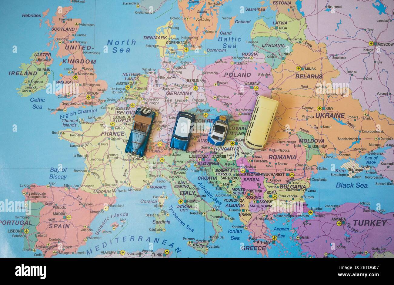 Set of small toy retro cars on the Europe map. Travel by car concept ...