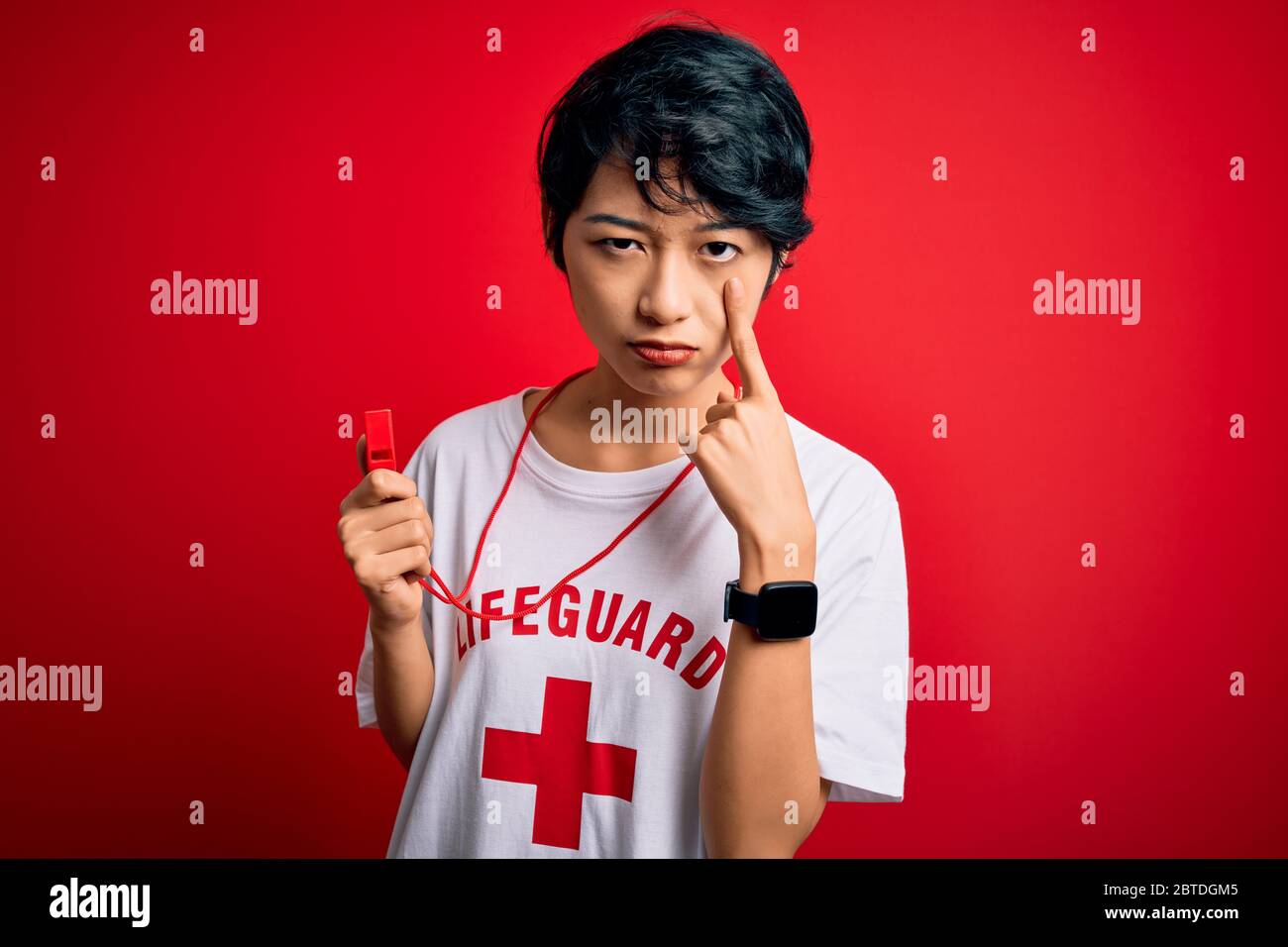 Young beautiful asian lifeguard girl wearing t-shirt with red cross ...