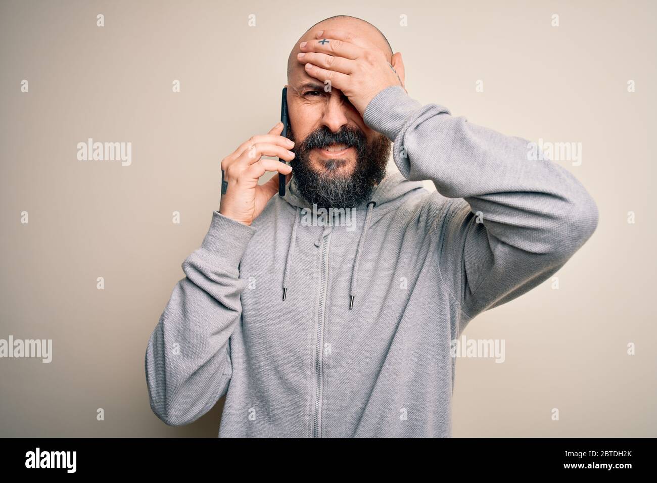 Handsome bald man with beard having conversation talking on the ...