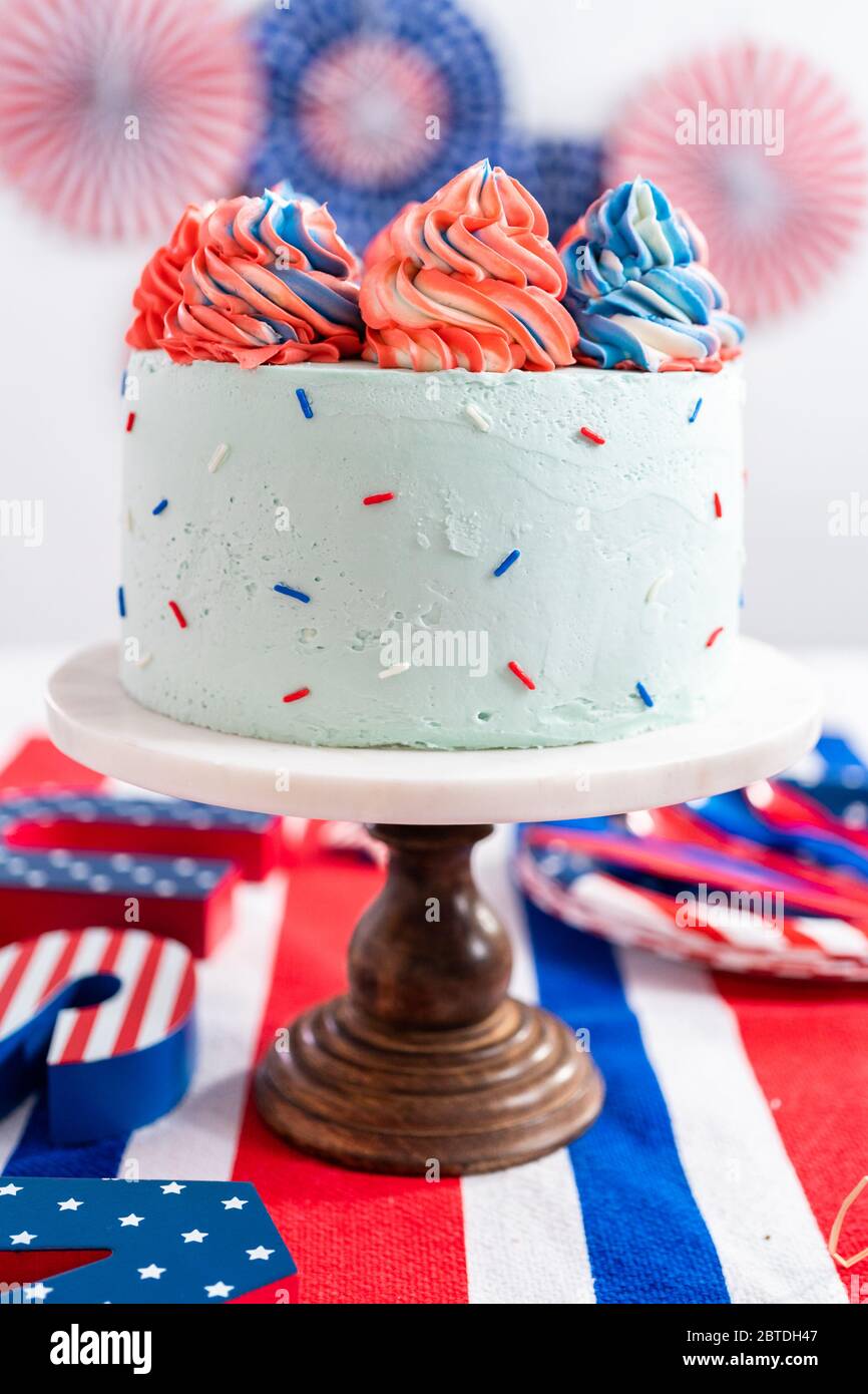 Red, white, and blue round vanilla cake with buttercream frosting for ...