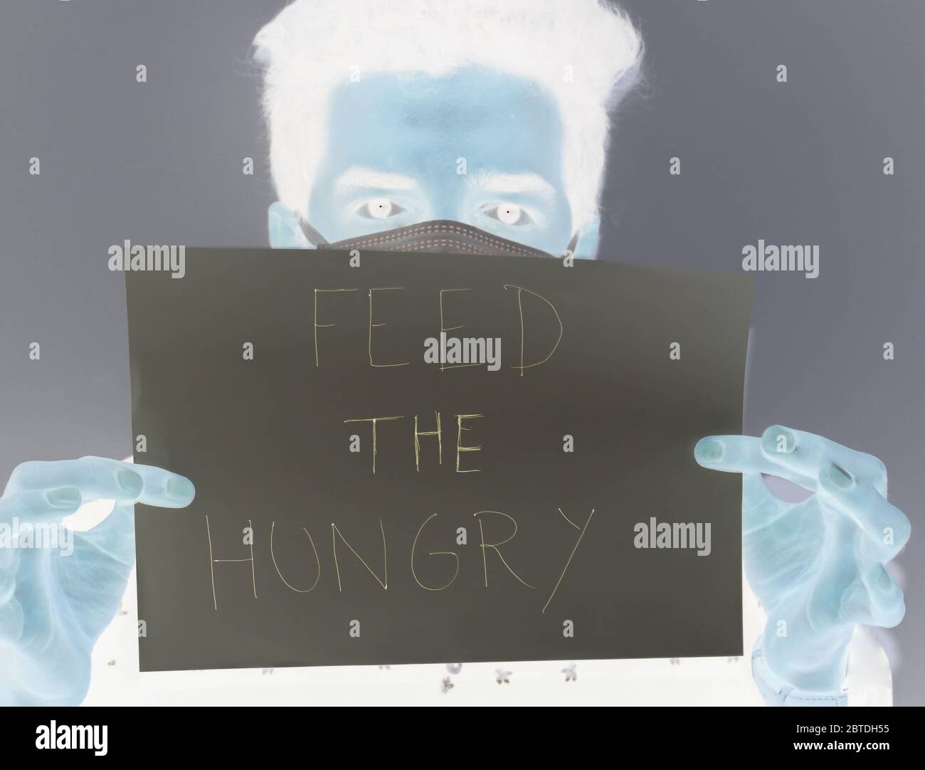 A man wearing face mask holding white board,concept of feed the hungry ...