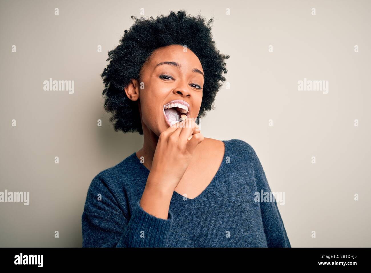 African american woman brushing her teeth using tooth brush and oral ...
