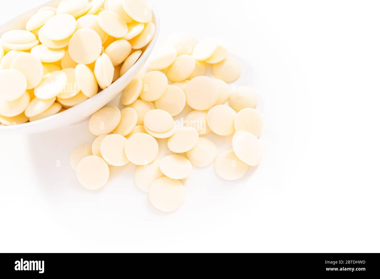 White round chocolate chips for melting chocolate shapes on a white ...