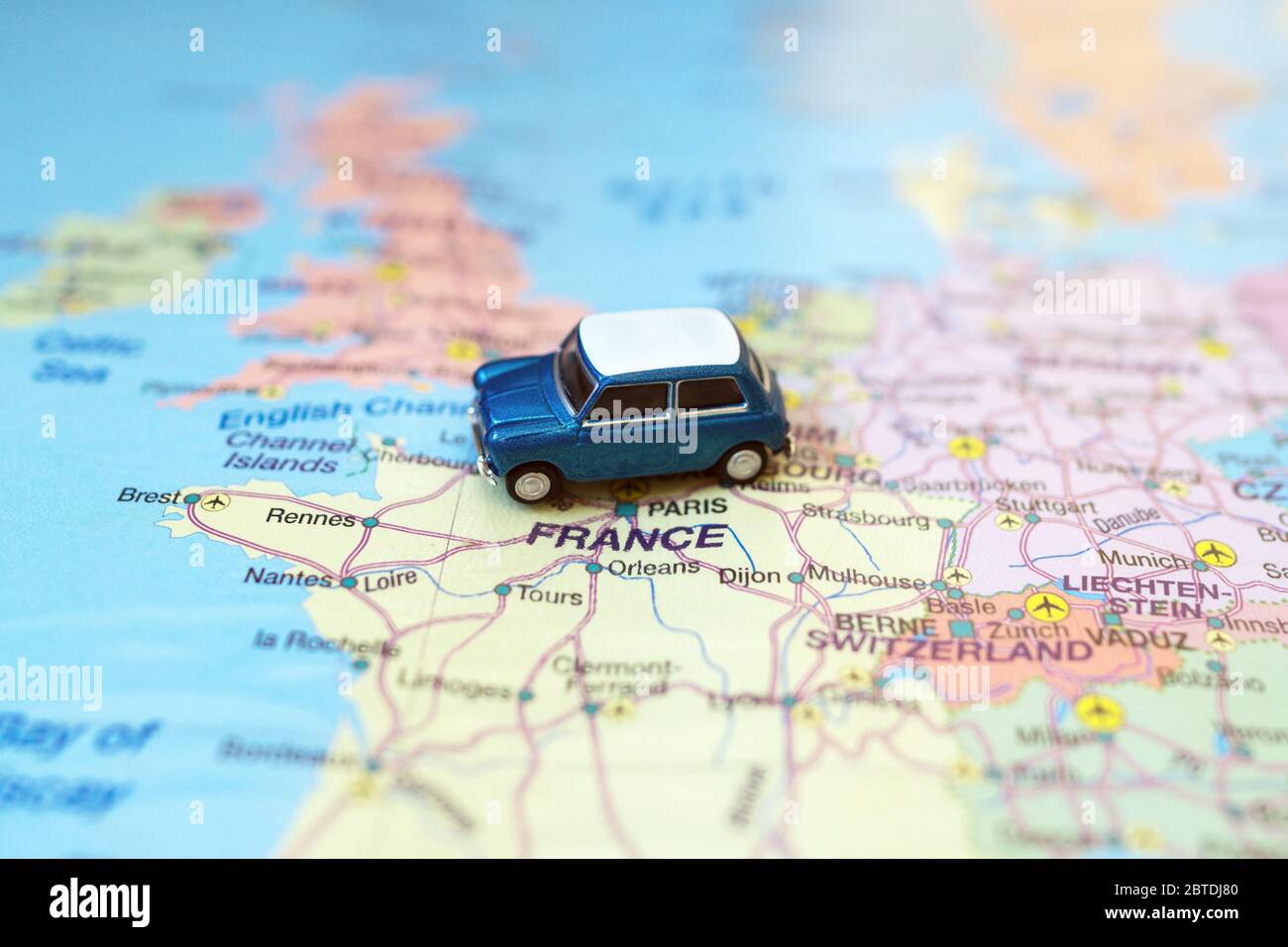 Small toy retro car on Europe map in France. Travel by car concept ...