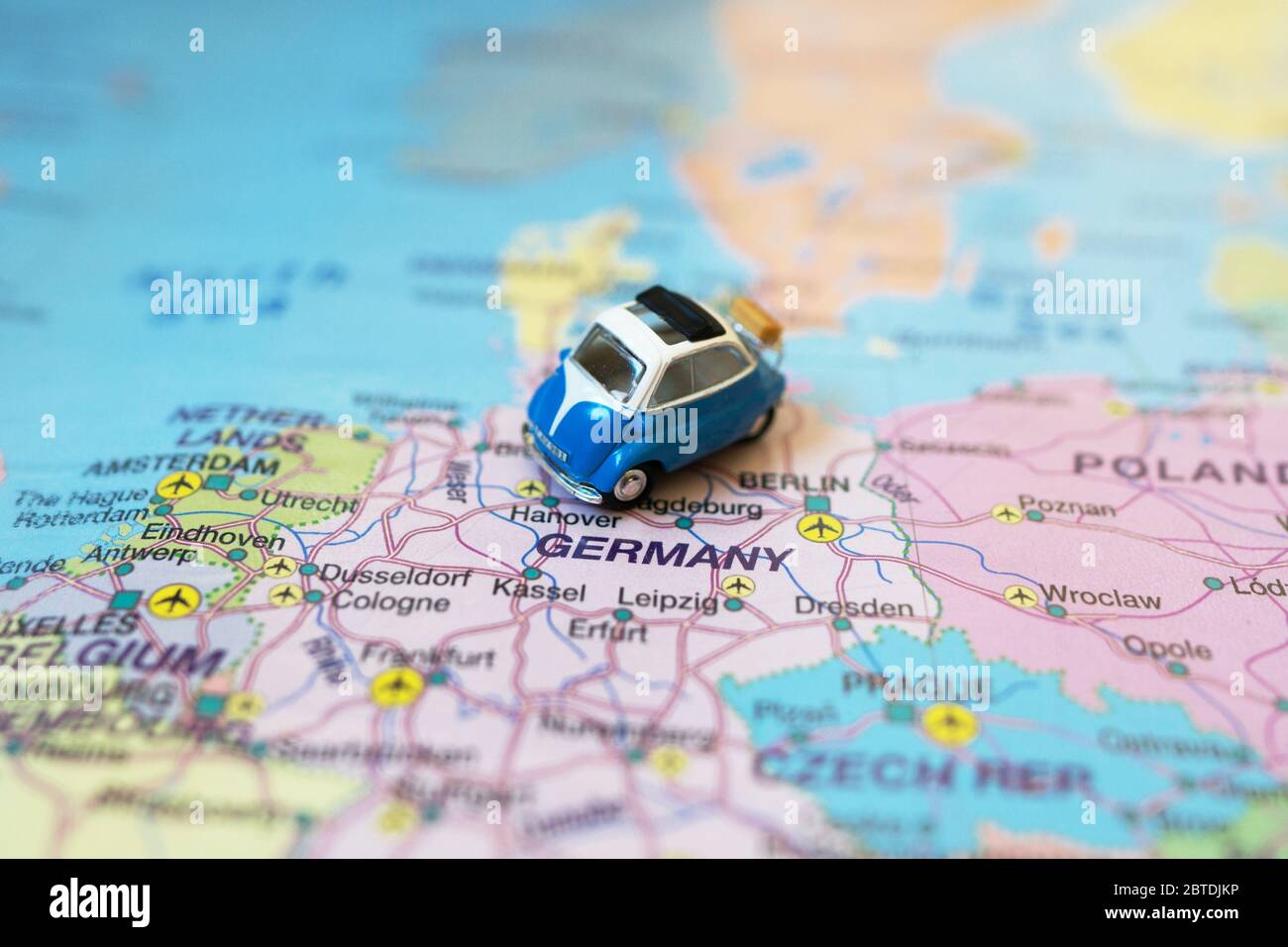 Small toy retro car on Europe map in Germany. Travel by car concept ...