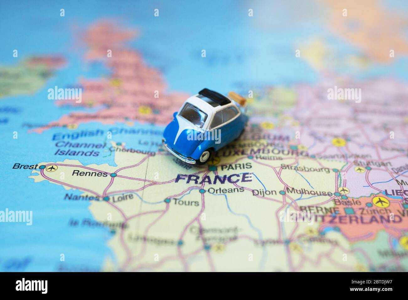 Small toy retro car on Europe map in France. Travel by car concept ...