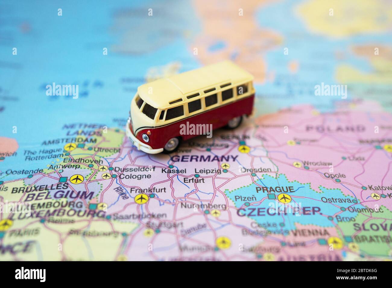 Small toy retro bus on Europe map in Germany. Travel by minivan concept ...