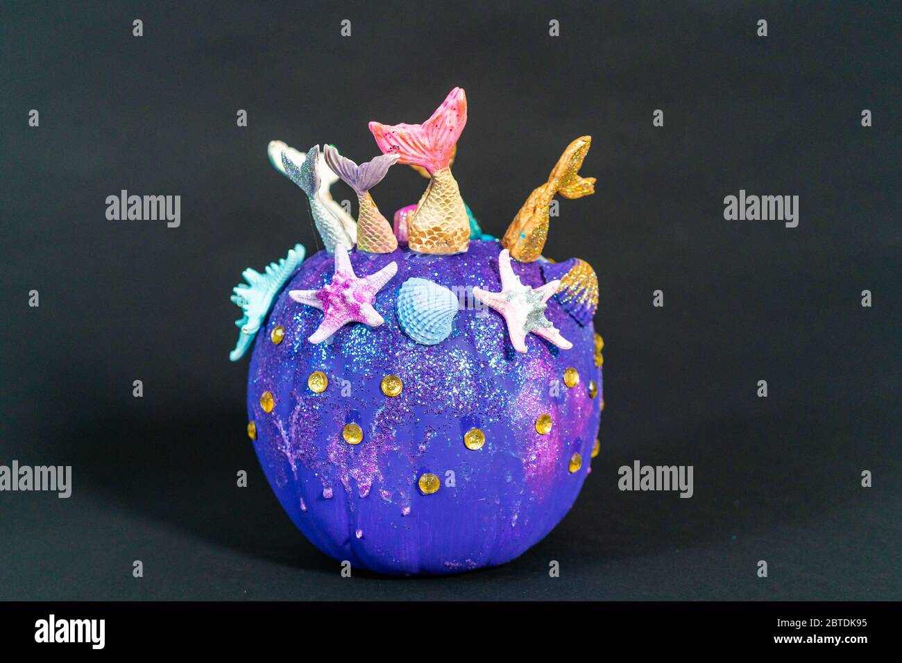 Halloween craft pumpkins decorated with mermaid tails, glitter, and ...