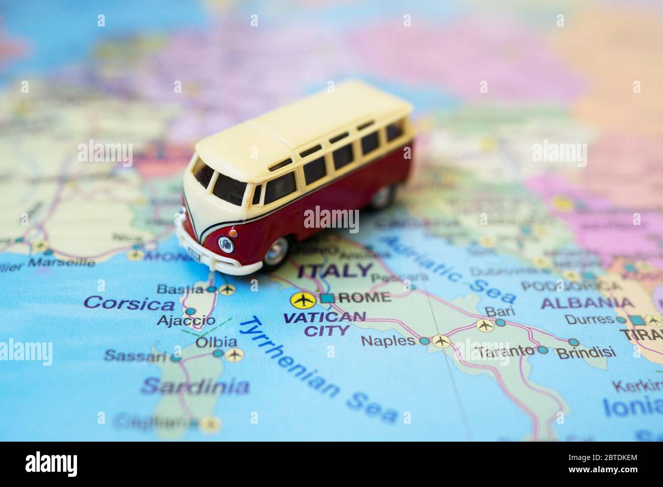 Small toy retro bus on Europe map in Italy. Travel by minivan concept ...