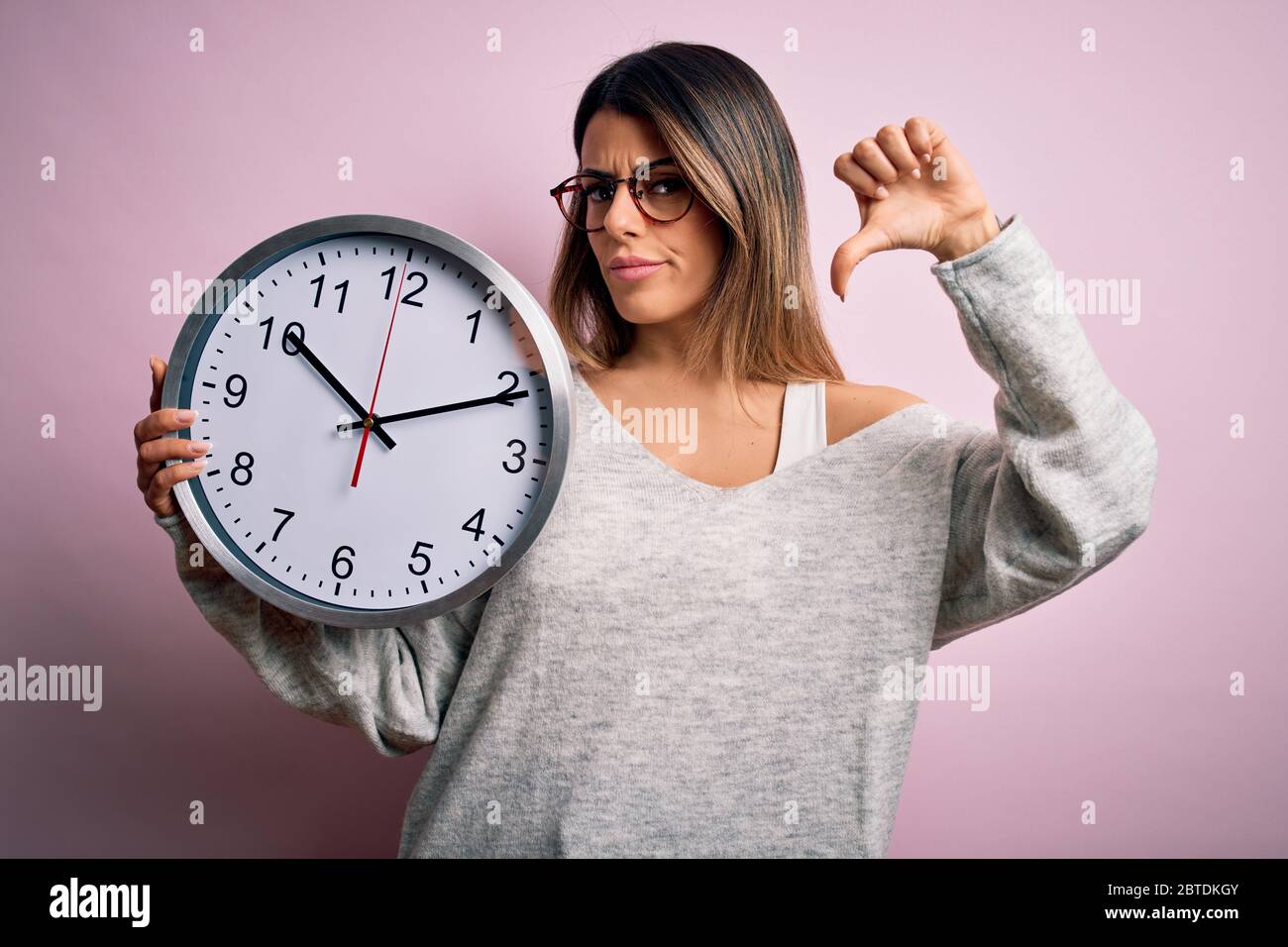 Young beautiful brunette woman wearing glasses doing countdown using ...