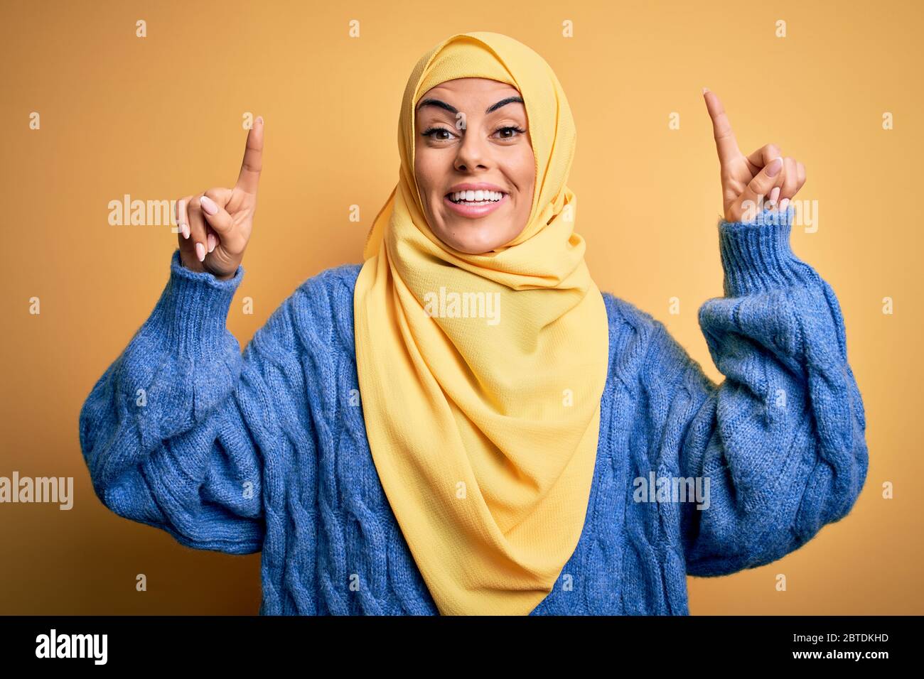 Young beautiful brunette muslim woman wearing arab hijab over isolated ...