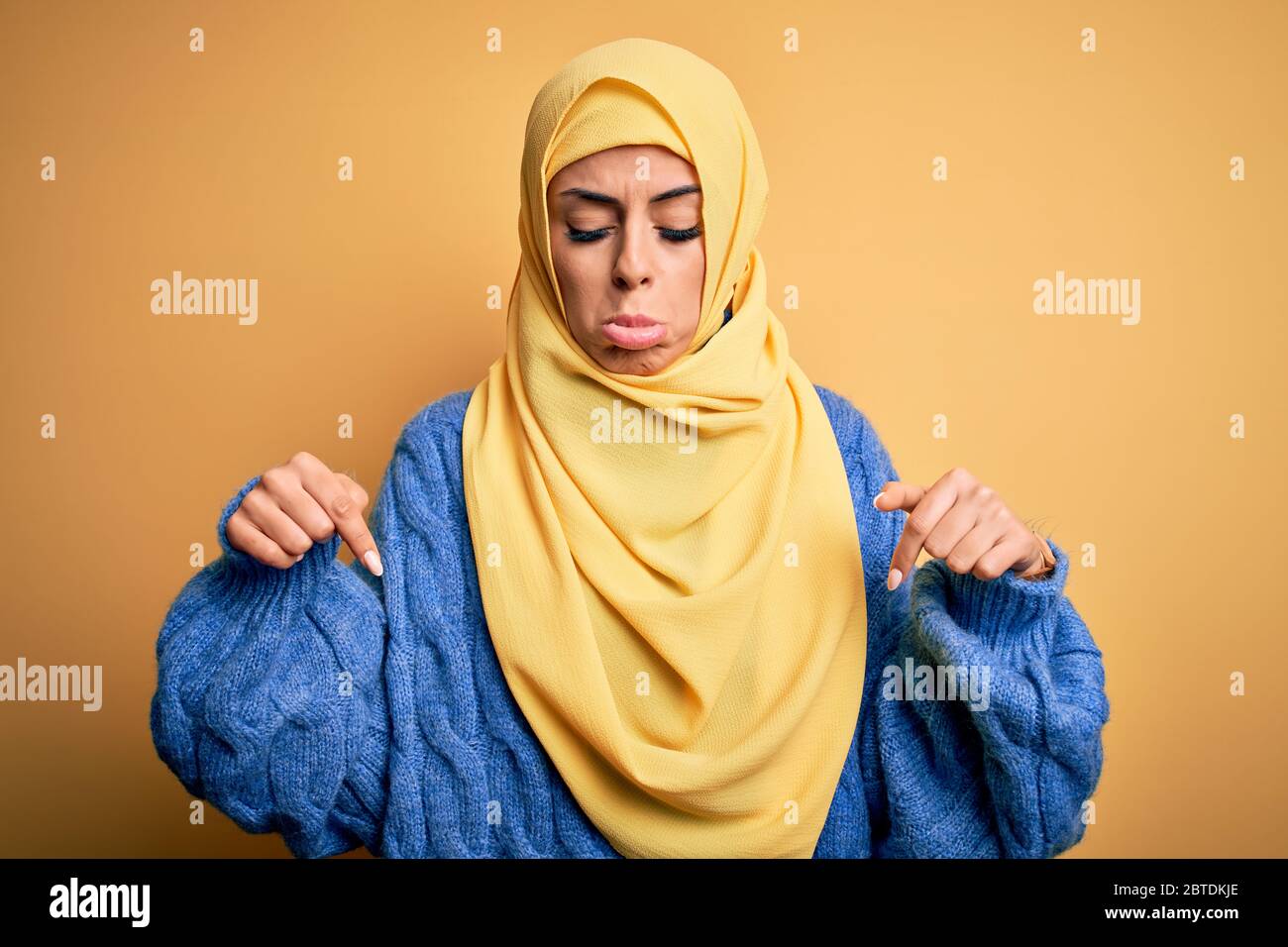 Young beautiful brunette muslim woman wearing arab hijab over isolated ...