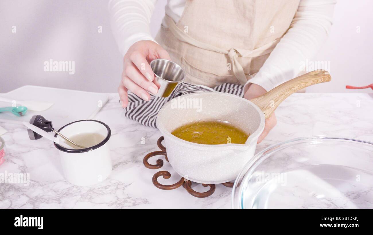 Step by step. Mixing in food flavor into caramelized sugar to make ...
