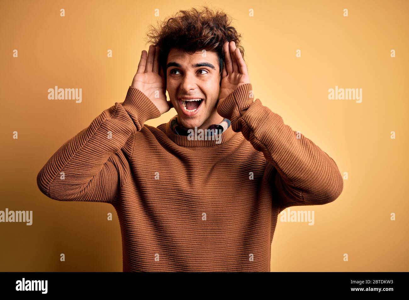 Young handsome man wearing casual shirt and sweater over isolated ...