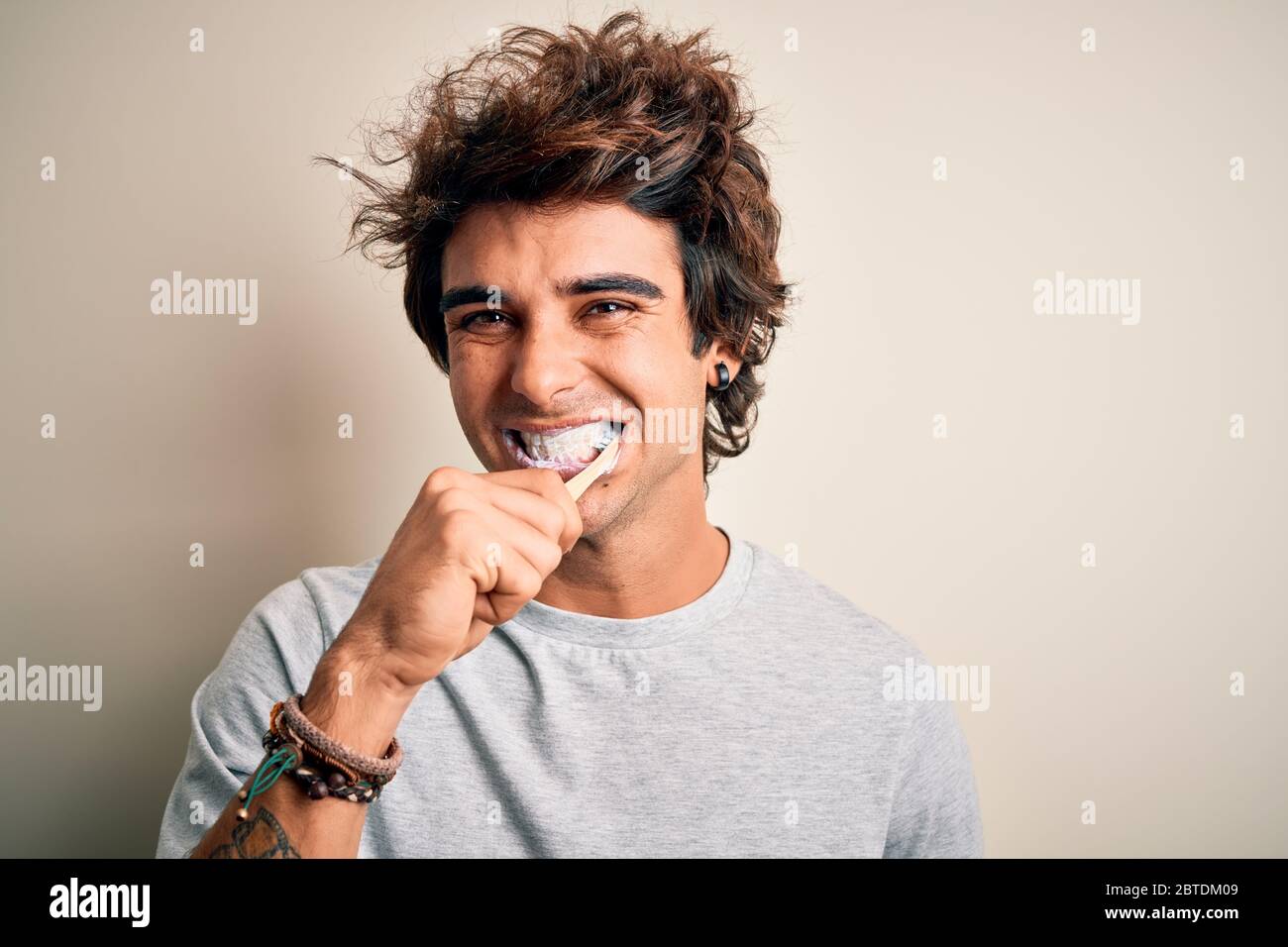 Young handsome man smiling happy. Standing with smile on face whasing ...