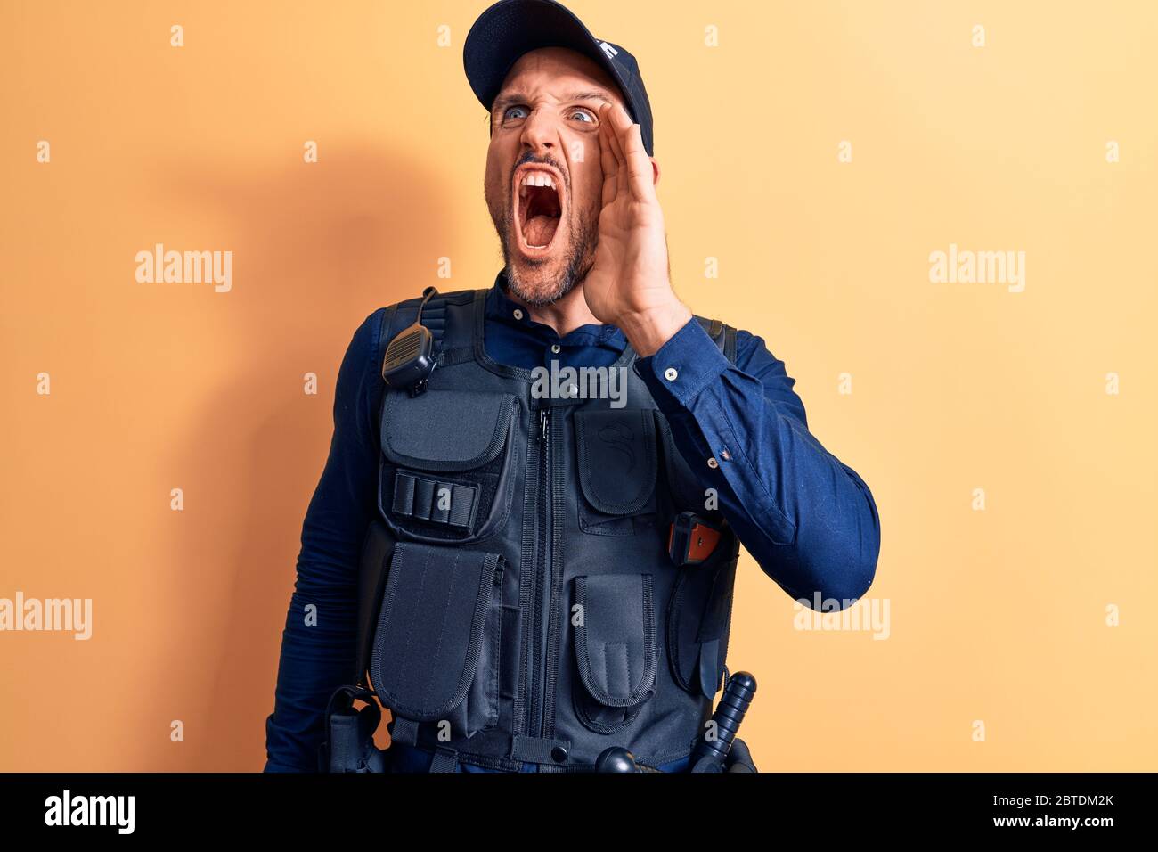 Young handsome policeman wearing police uniform and bulletprof over ...