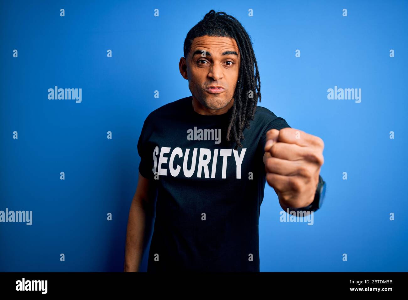 Young african american afro safeguard man with dreadlocks wearing ...