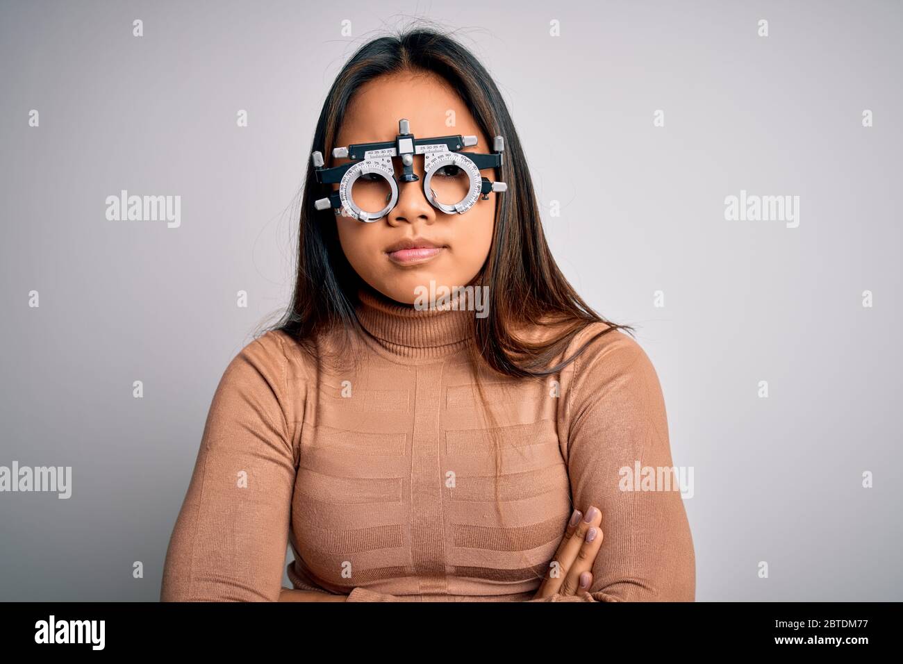 Young asian optical girl controlling eyesight using optometry glasses ...