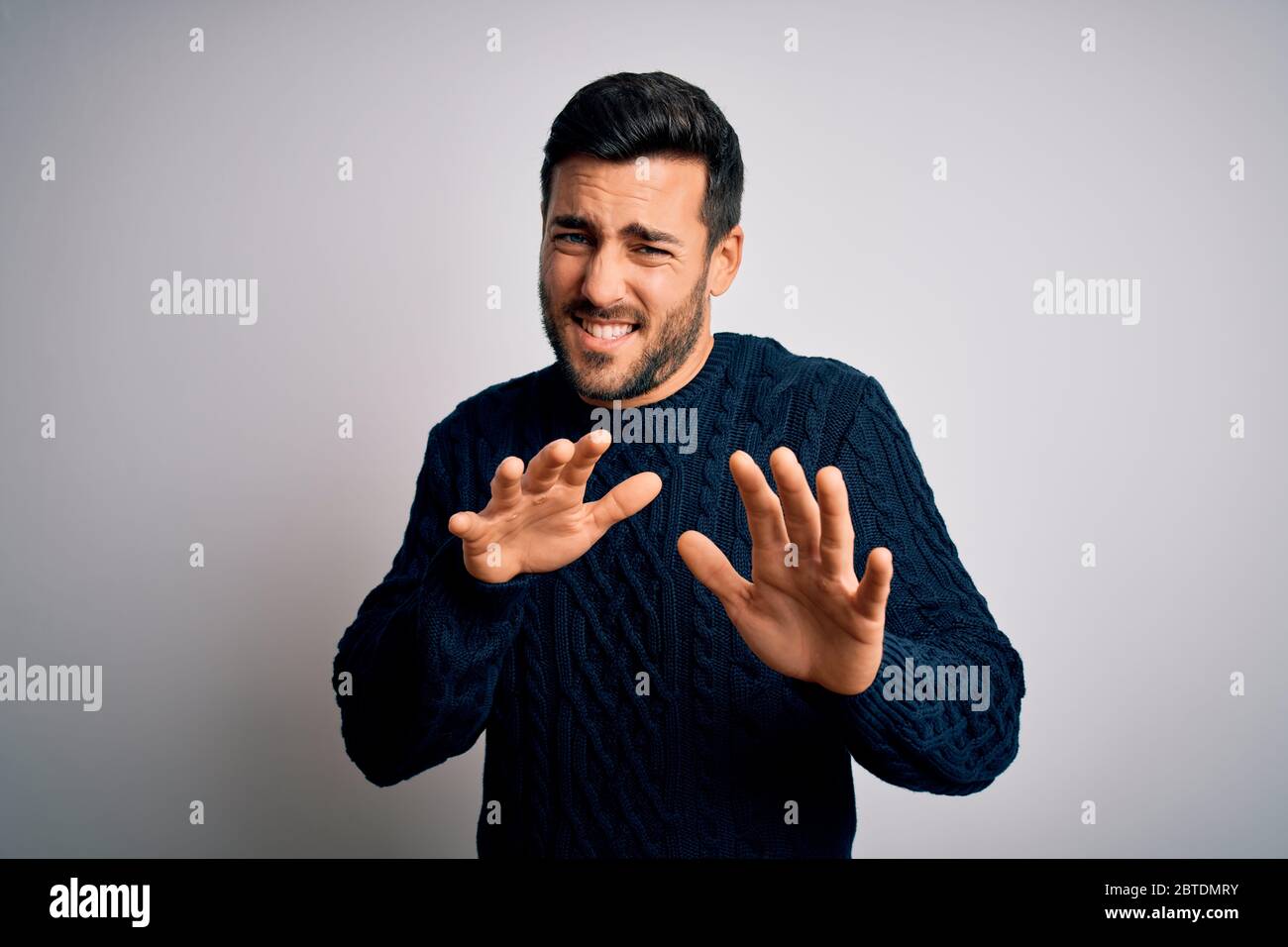 Young handsome man with beard wearing casual sweater standing over ...