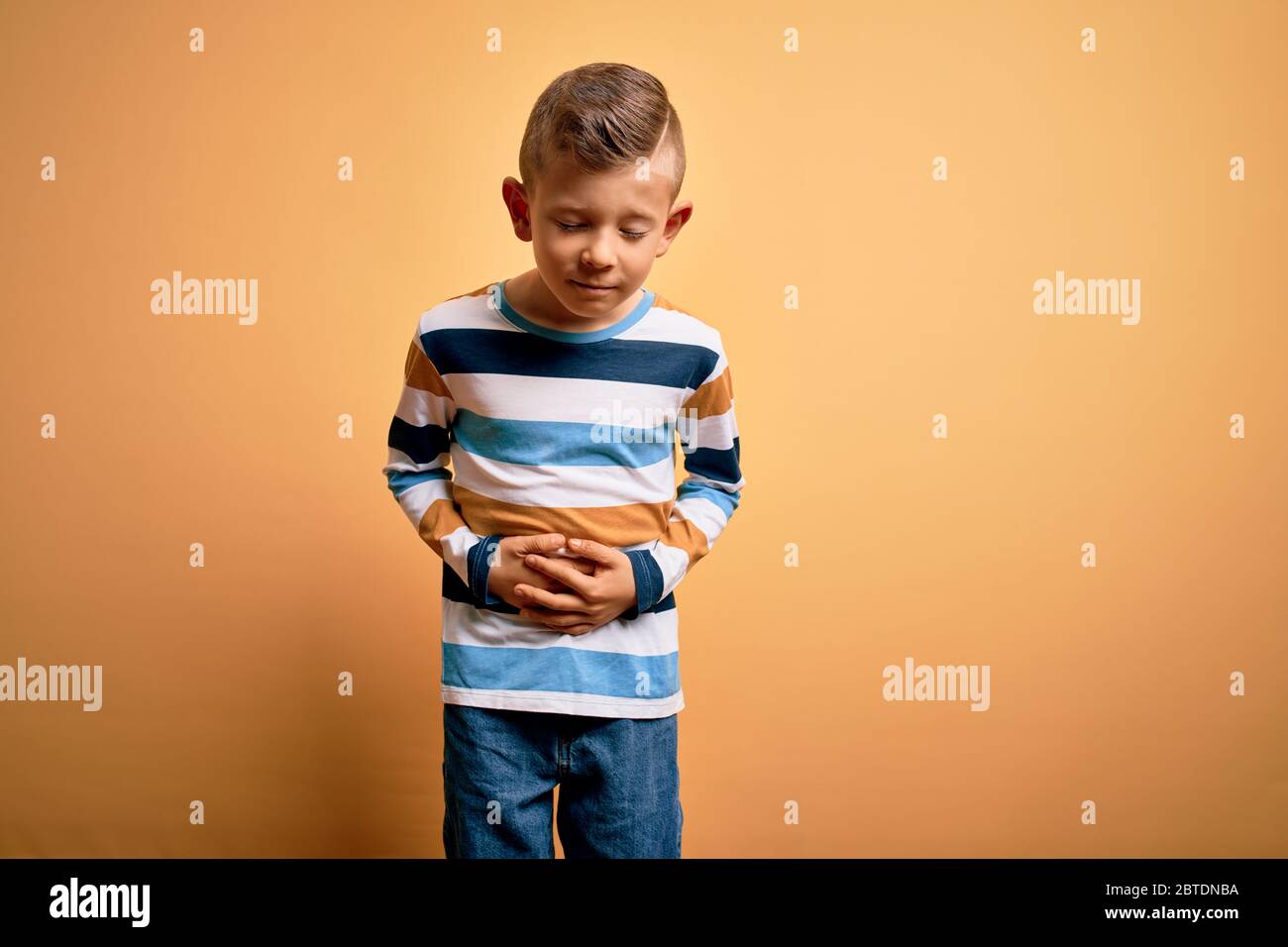Young little caucasian kid with blue eyes wearing colorful striped ...