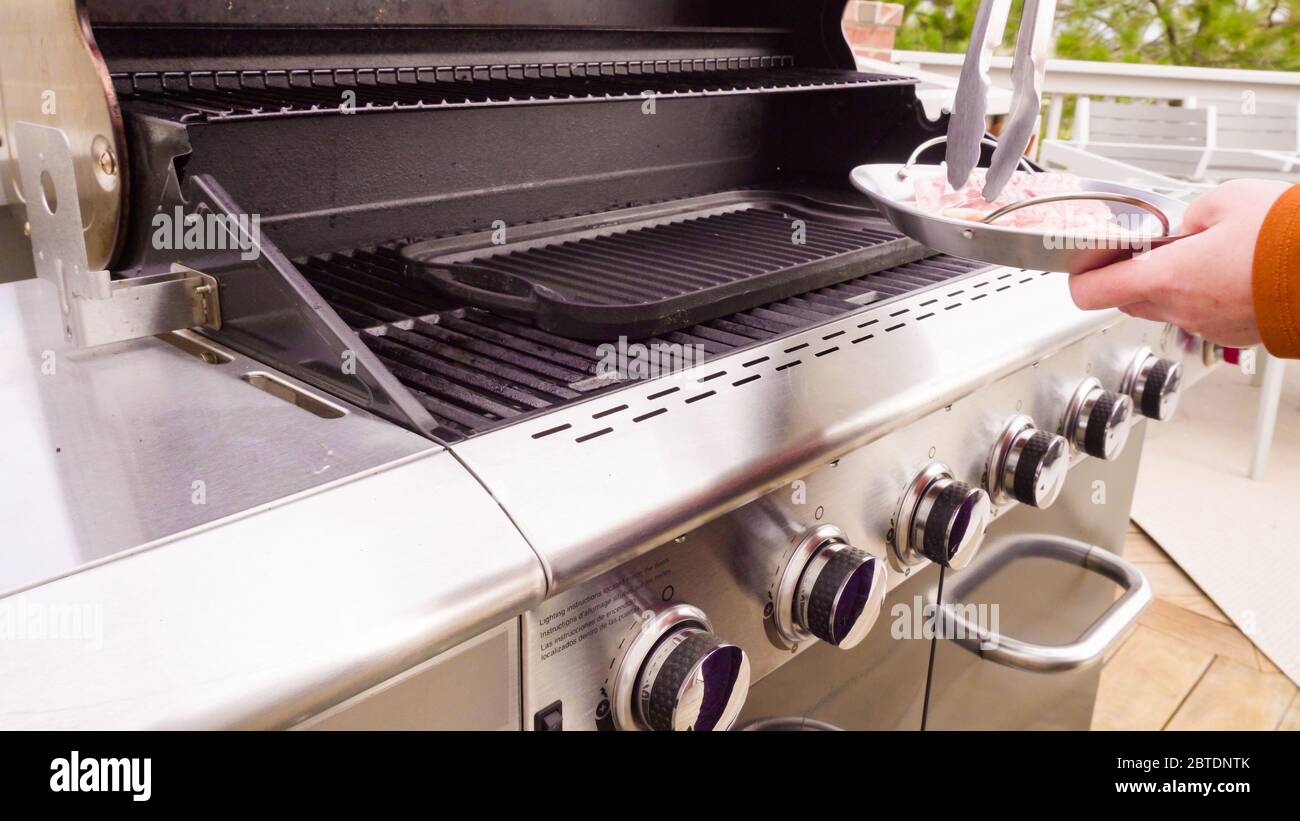 Cooking bacon stips on an outdoor gas grill Stock Photo - Alamy