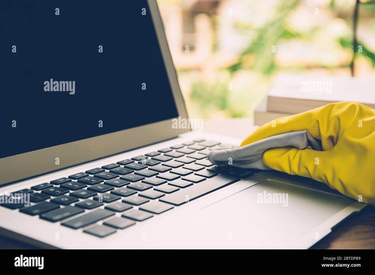 Hand of man cleaning keyboard computer with antibacterial for protect ...