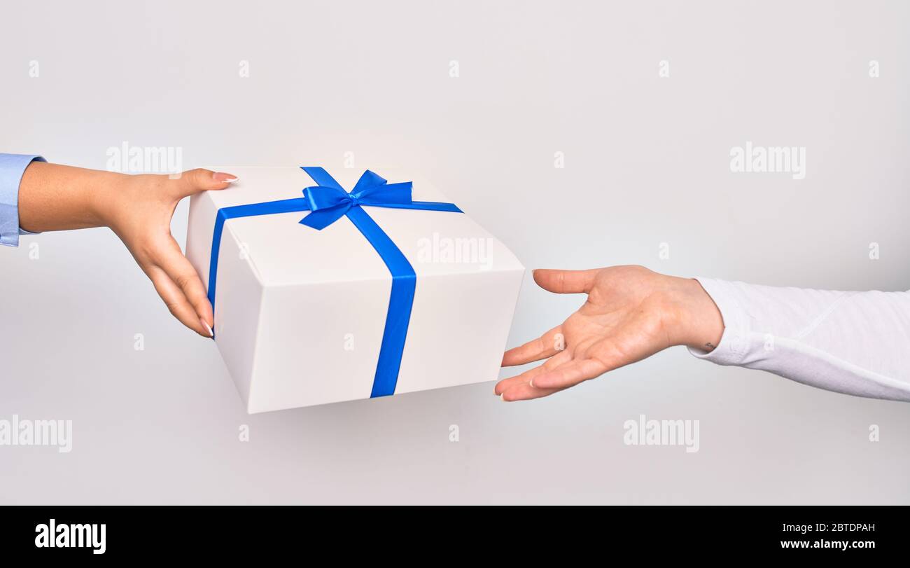Hand of caucasian young woman giving birthday gift to other person over ...