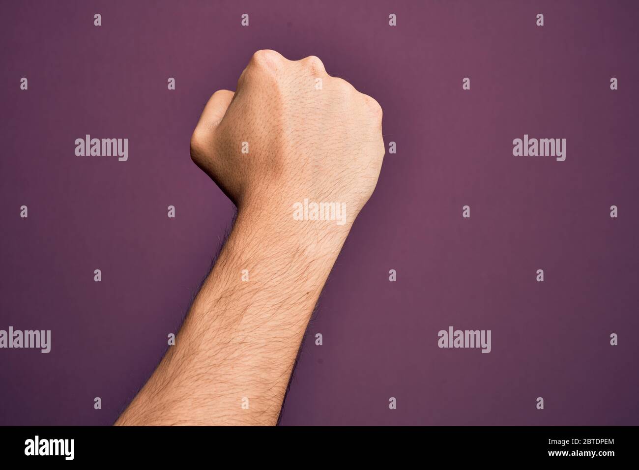Hand of caucasian young man showing fingers over isolated purple ...
