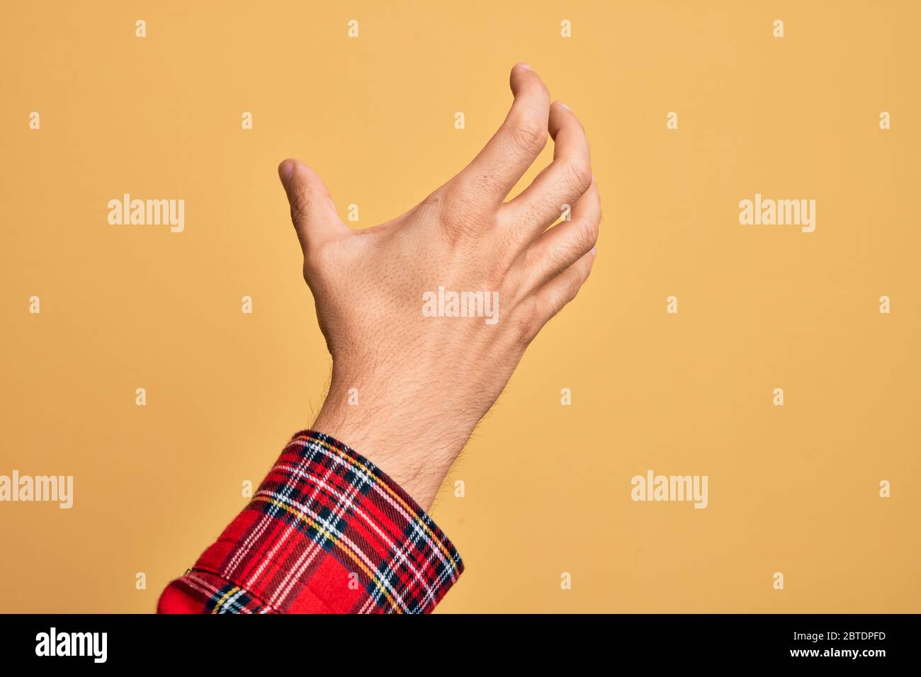 Hand of caucasian young man showing fingers over isolated yellow ...